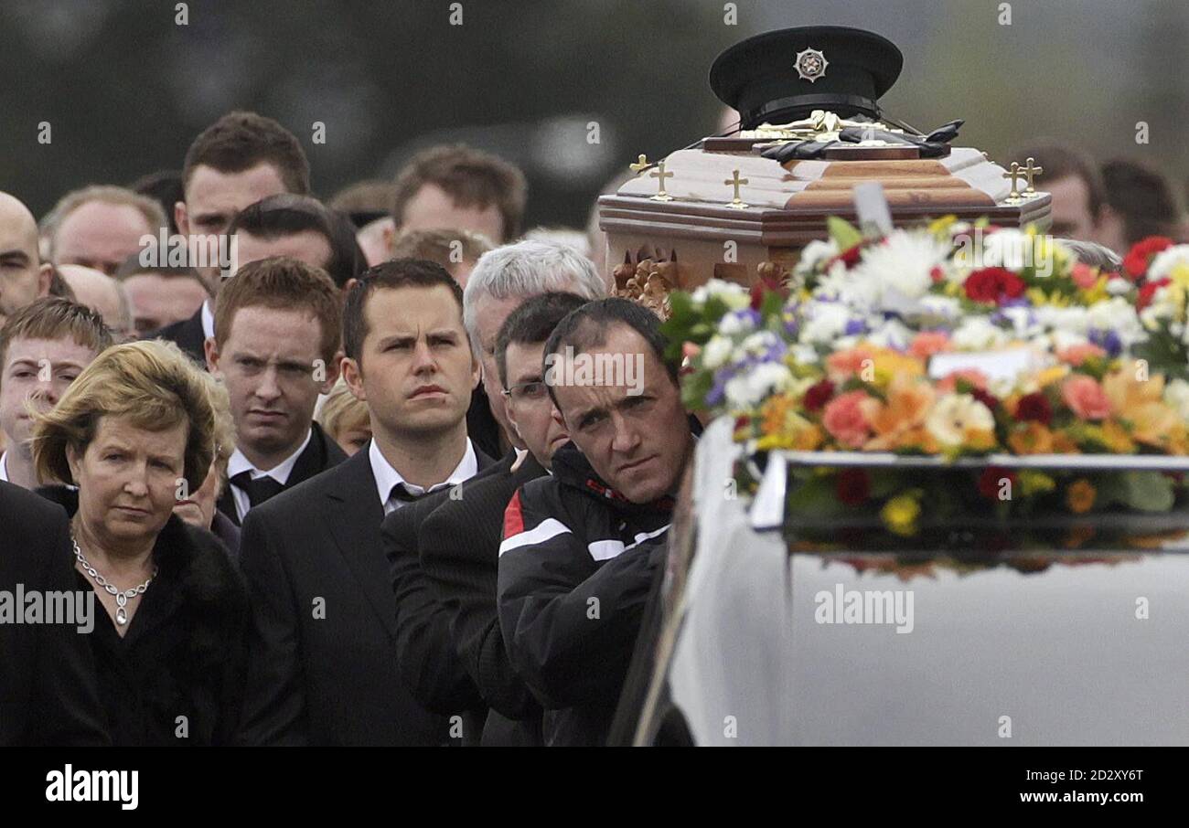 Tyrone GAA Captain Brian Dooher carries the coffin of PSNI Constable ...
