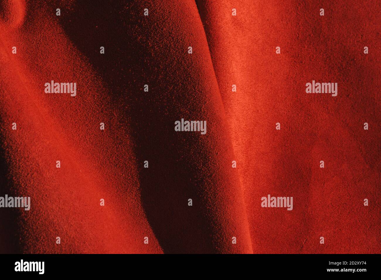 Red matte background of suede fabric, closeup. Velvet texture of ...