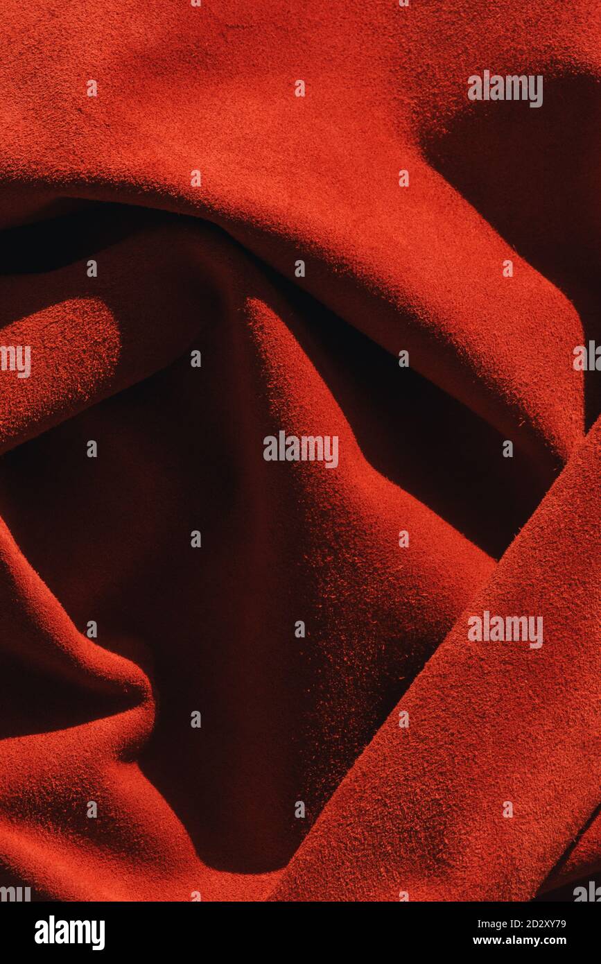 Red matte background of suede fabric, closeup. Velvet texture of ...