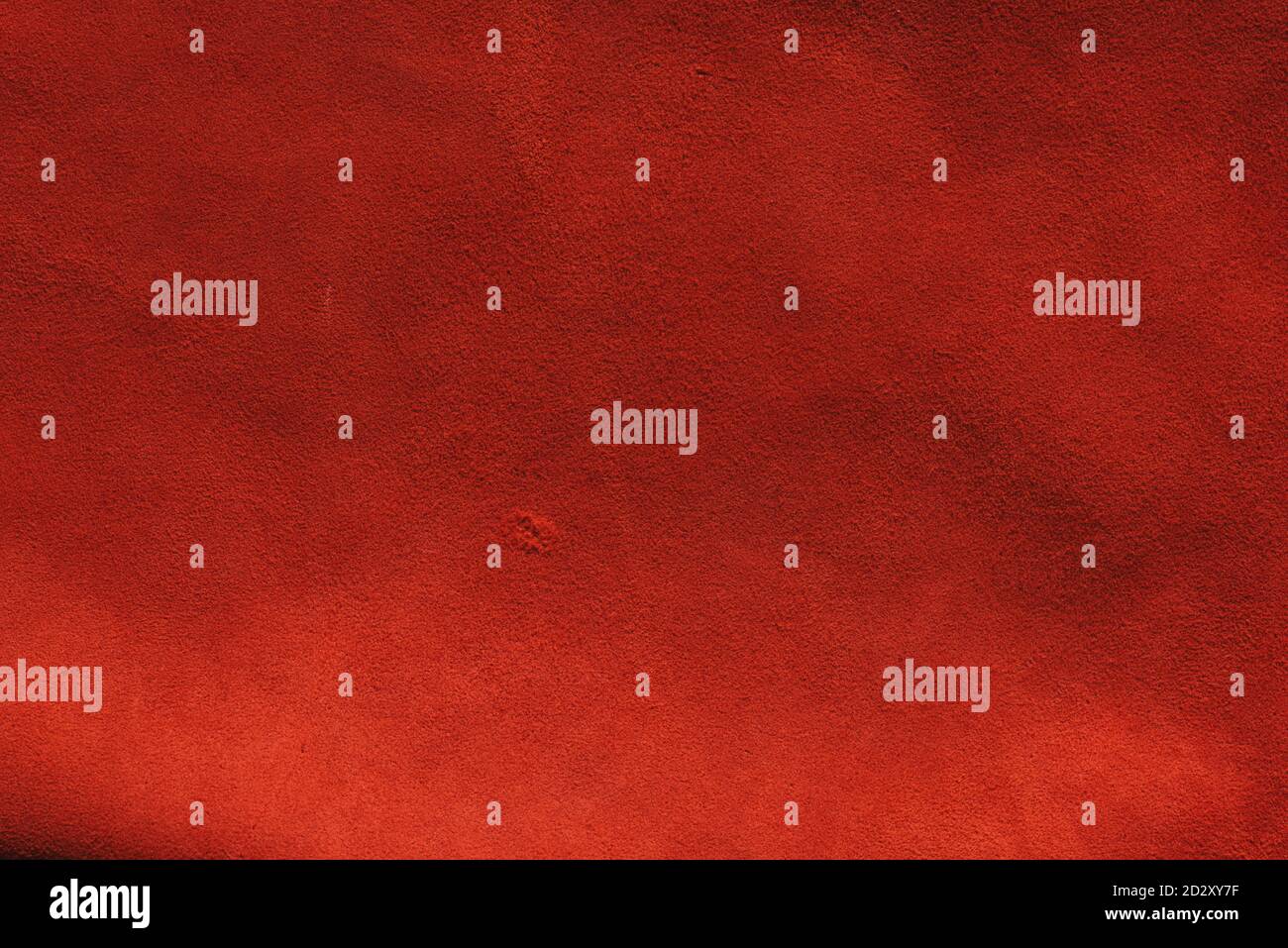 Red matte background of suede fabric, closeup. Velvet texture of ...