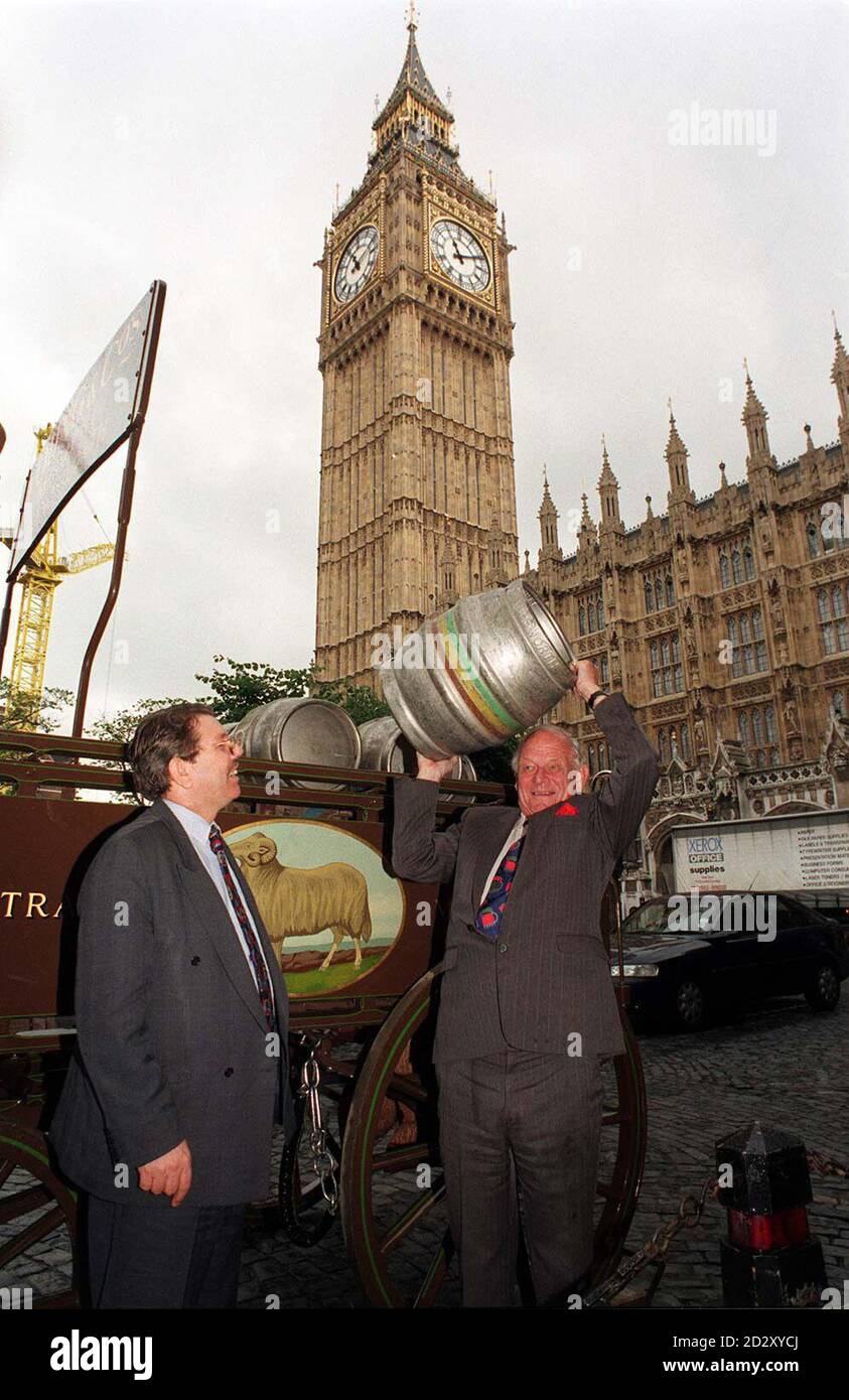 John Young, chairman of Young's of Wandsworth (right), hands over a keg ...