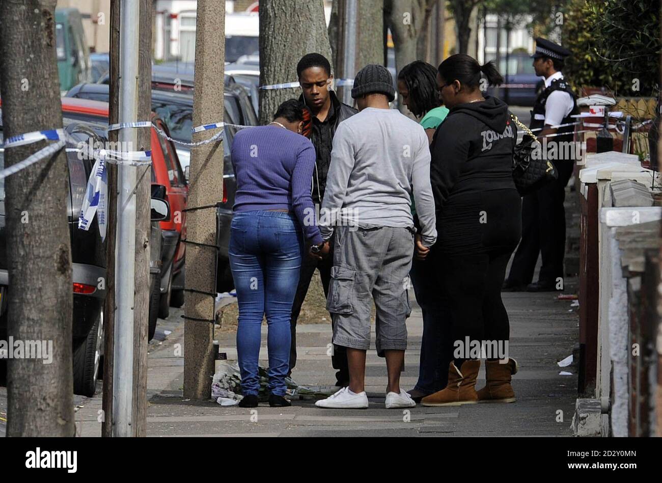 Mourners at the scene in Edmonton, north London, where 15-year-old ...