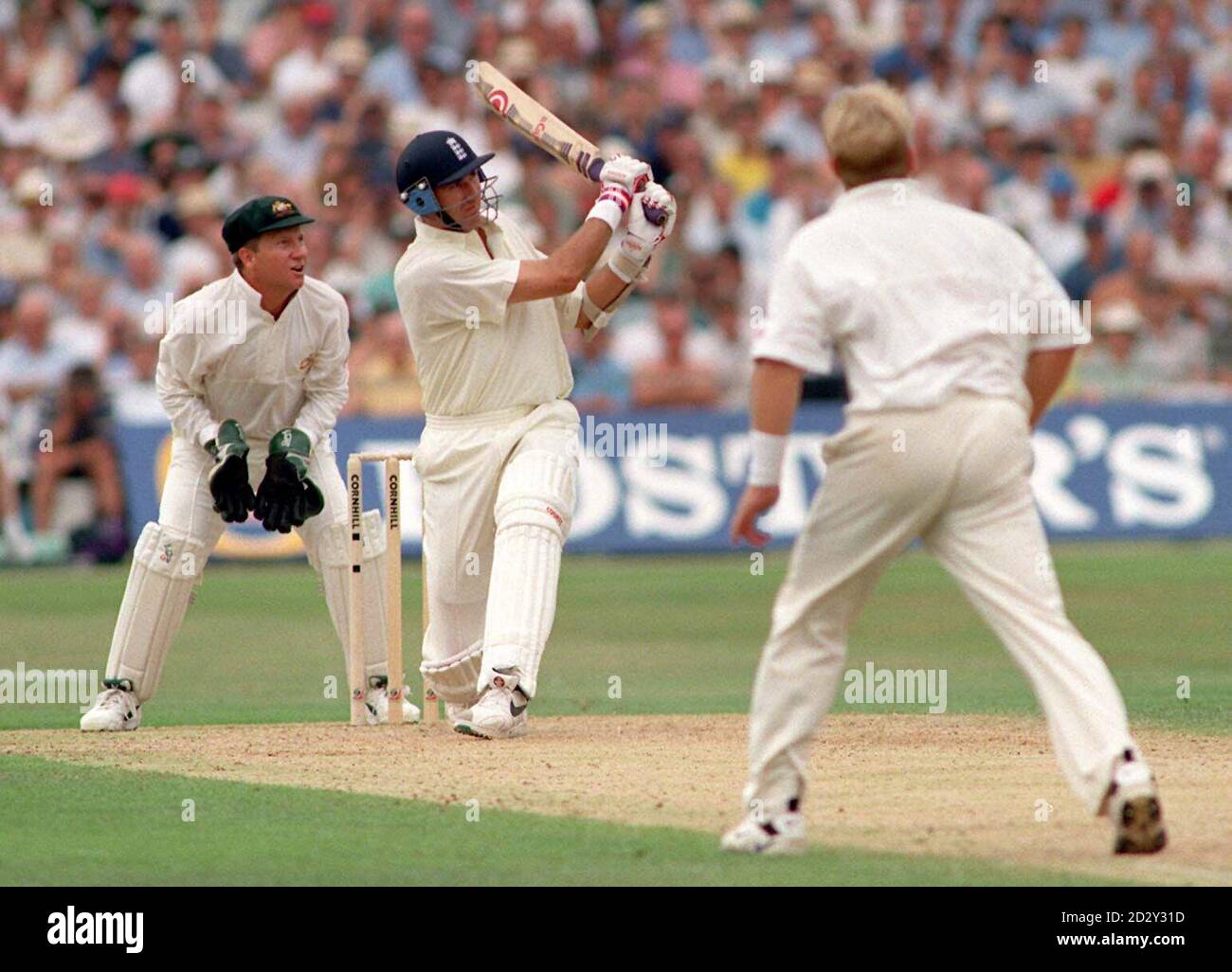 Andy Caddick of England crashes the bowling of Australia's Shane Warne ...