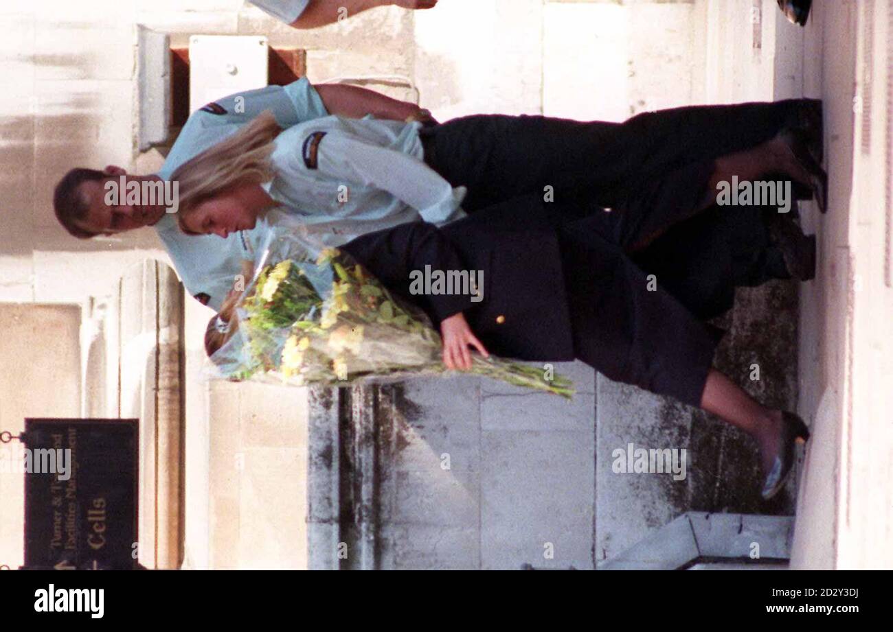 Escorted by prison officers, nurse Amanda Jenkinson, hiding behind a ...