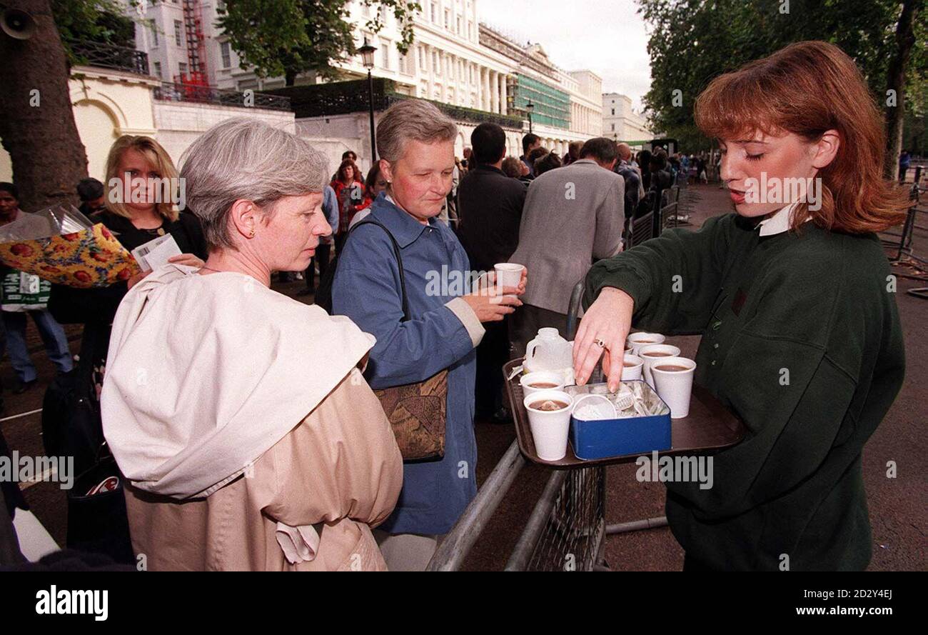 Karen Lewis (right), Harrods employee hands out refreshments today ...