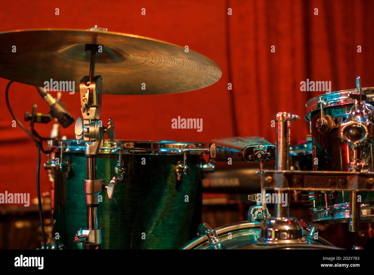 Green drum set on red background. Percussion instruments at a jazz ...