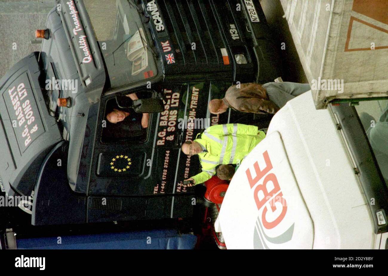 A marshal talks to lorry drivers, who are stacked on the M20 near ...