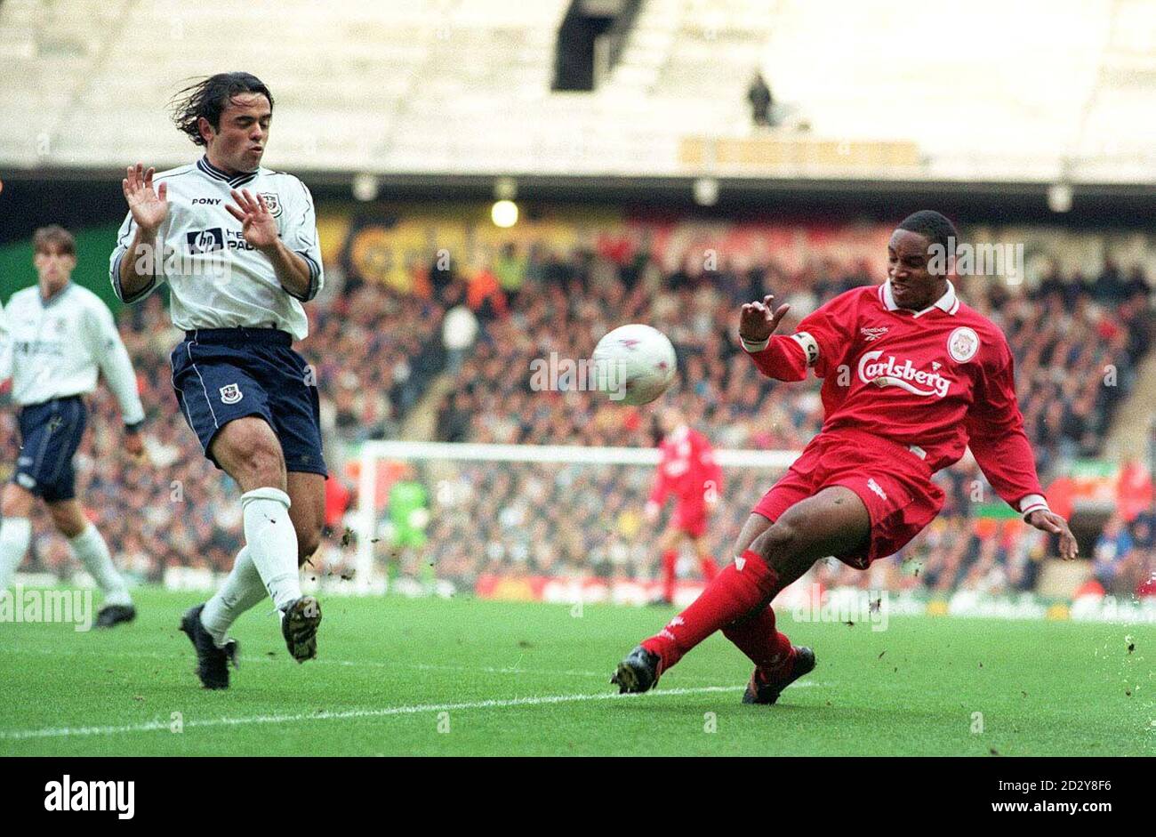 Liverpool's Paul Ince runs (right) to collect a ball from Spurs ...