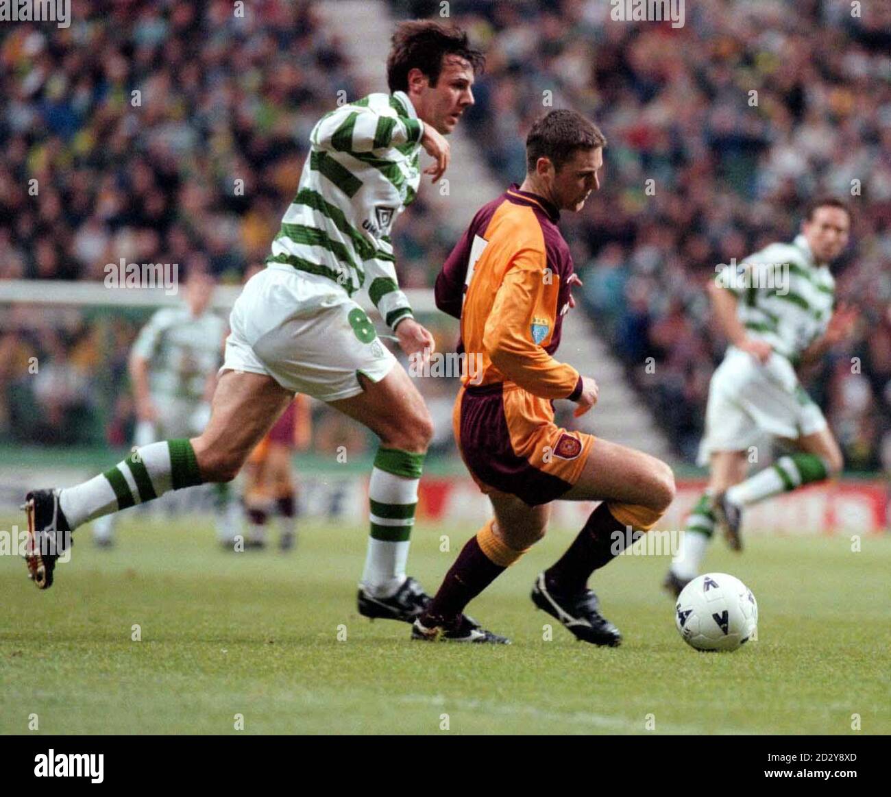 Celtic's Craig Burley chases after Motherwell's Steven Craigen during ...