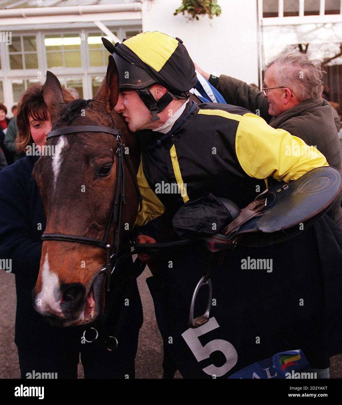 Jockey Tom Jenks kisses the ear of his mount 'Earth Summit' after they ...