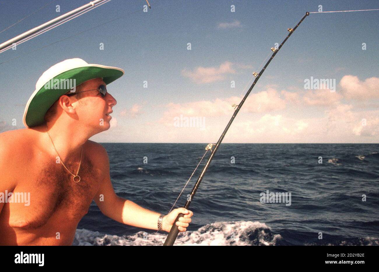 England cricketer Robert Croft fishes from a boat off the island of ...