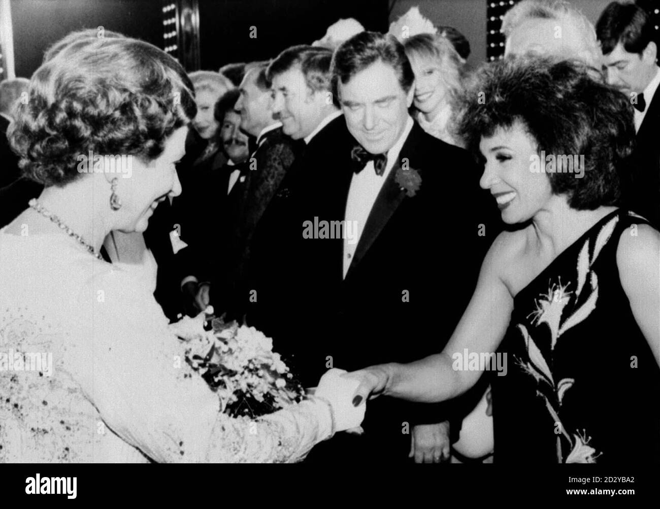 Queen Elizabeth II greeting singer Shirley Bassey backstage at the ...