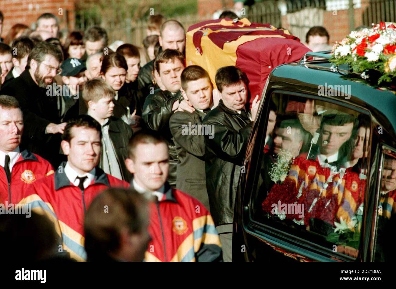 Sinn Fein President Gerry Adams (left, glasses), walks behind the ...