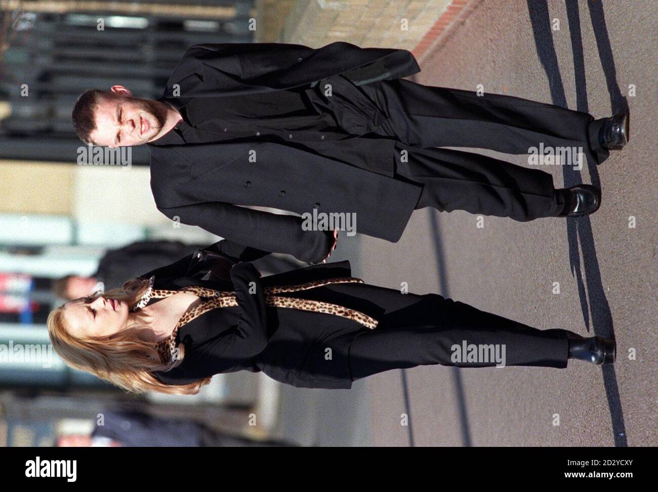 Pop star Brian Harvey of the band, East 17, arrives hand in hand with ...