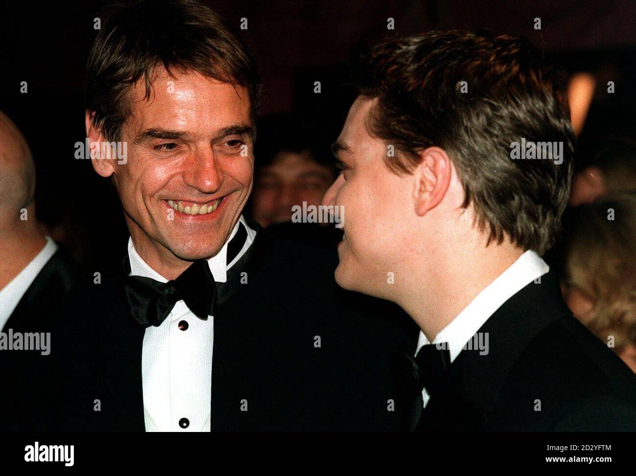 Titanic star Leonardo DiCaprio (rights) chats with co star Jeremy Irons ...