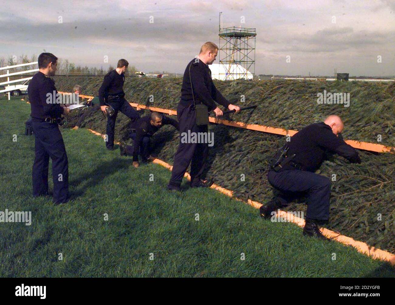 Members of the Merseyside Police Operational Support Group check fences ...