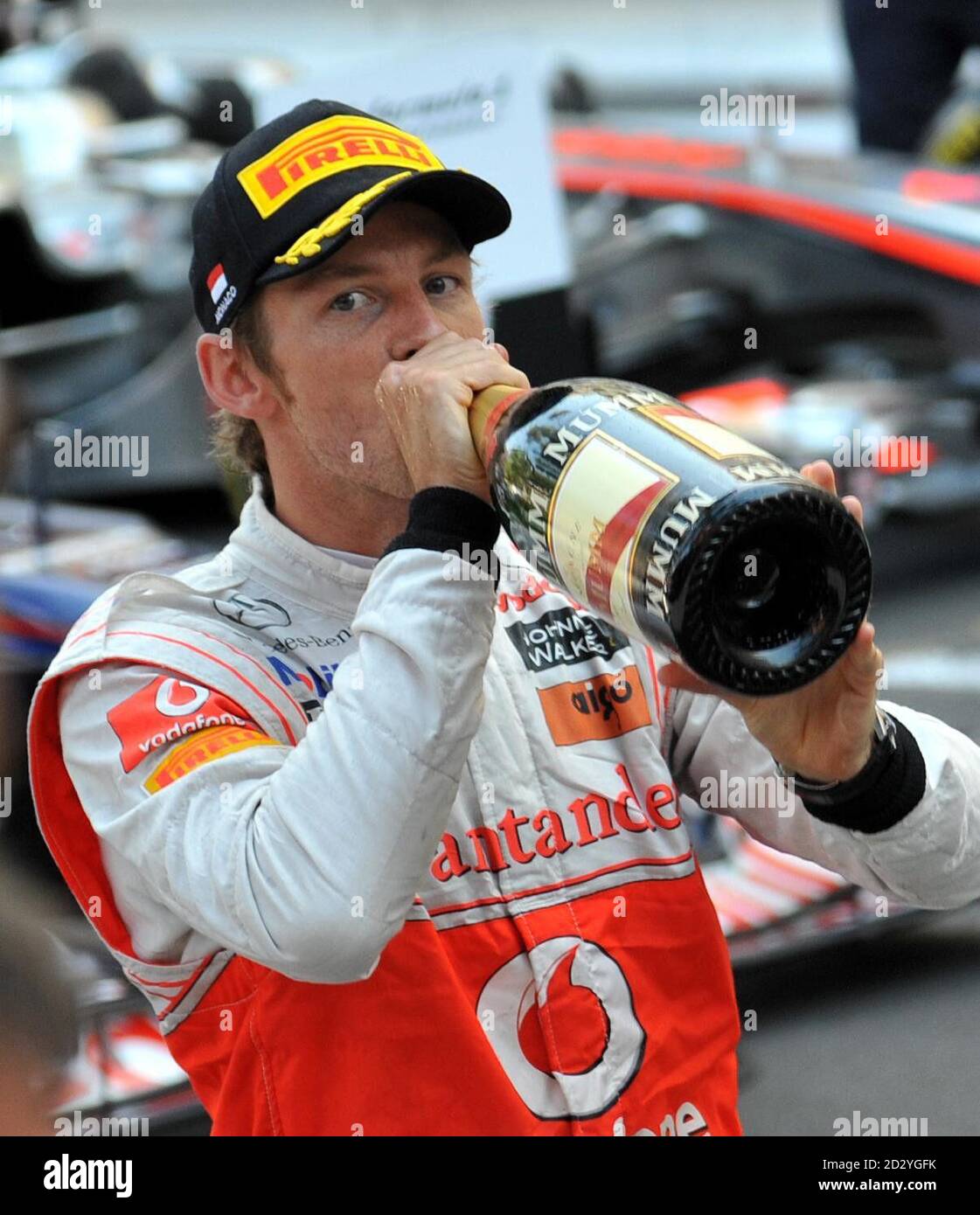 Great Britain's Jenson Button drinks champagne after finishing third ...