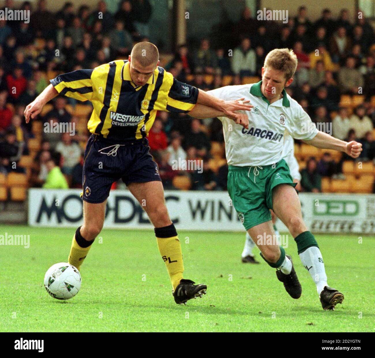 Andy Gurney (left) Torquay gets the ball past Andy Farrell (Rochdale ...