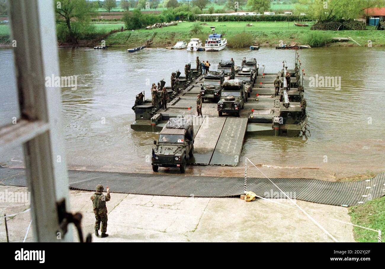 The first of the army vehicles is driven from a M3 mobile bridge after ...