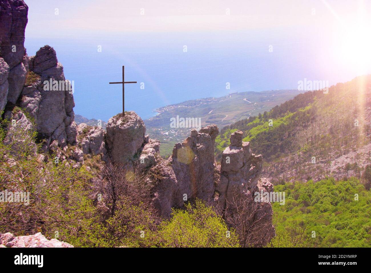 Large wooden cross at peak of the mountain. Church symbol on the rocks ...