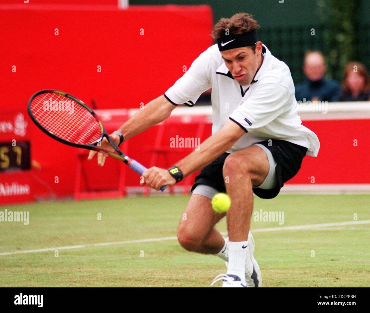England's Greg Rusedski stoops to return to Golmaro during their rain ...