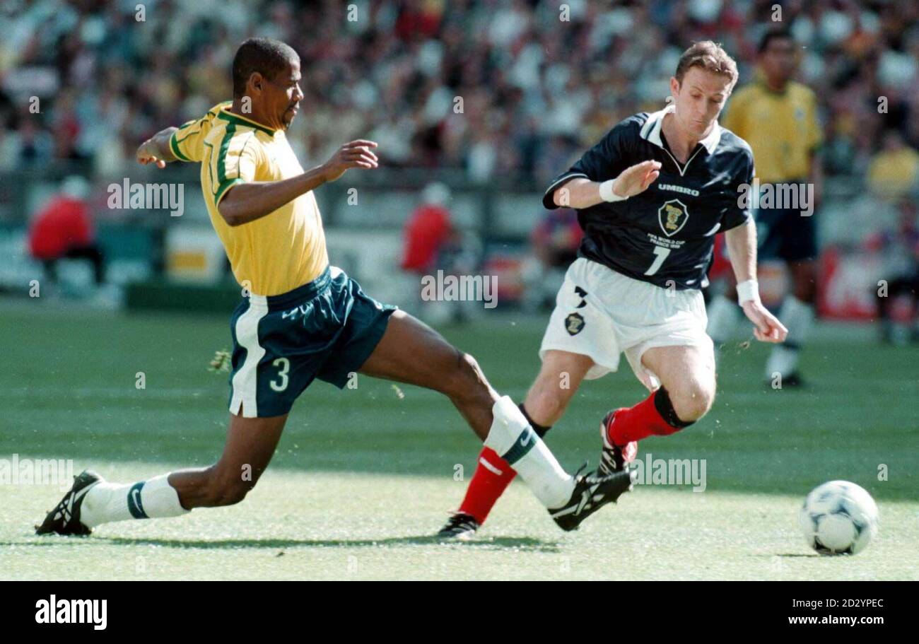 Scotland's Kevin Gallagher (right) attempts to pass Brasil's Aldair ...