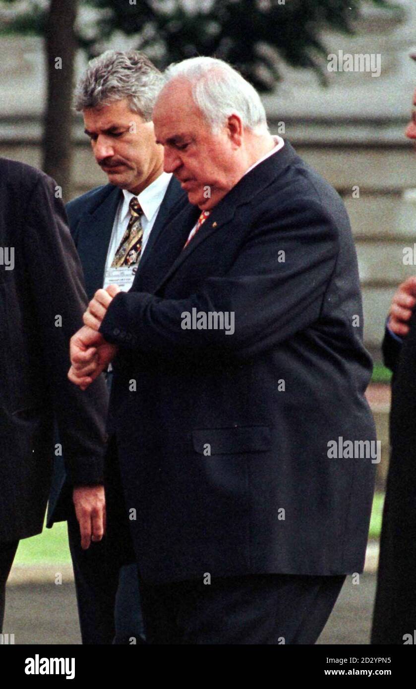 German Chancellor Helmut Kohl checks his watch as arrives for the last ...