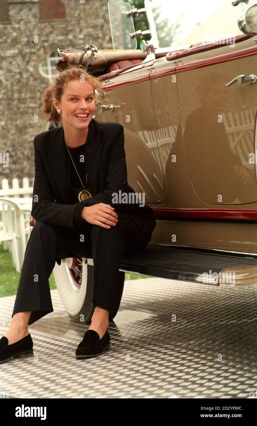 Supermodel Eva Herzigova sits beside a Chrysler CG Imperial during her ...