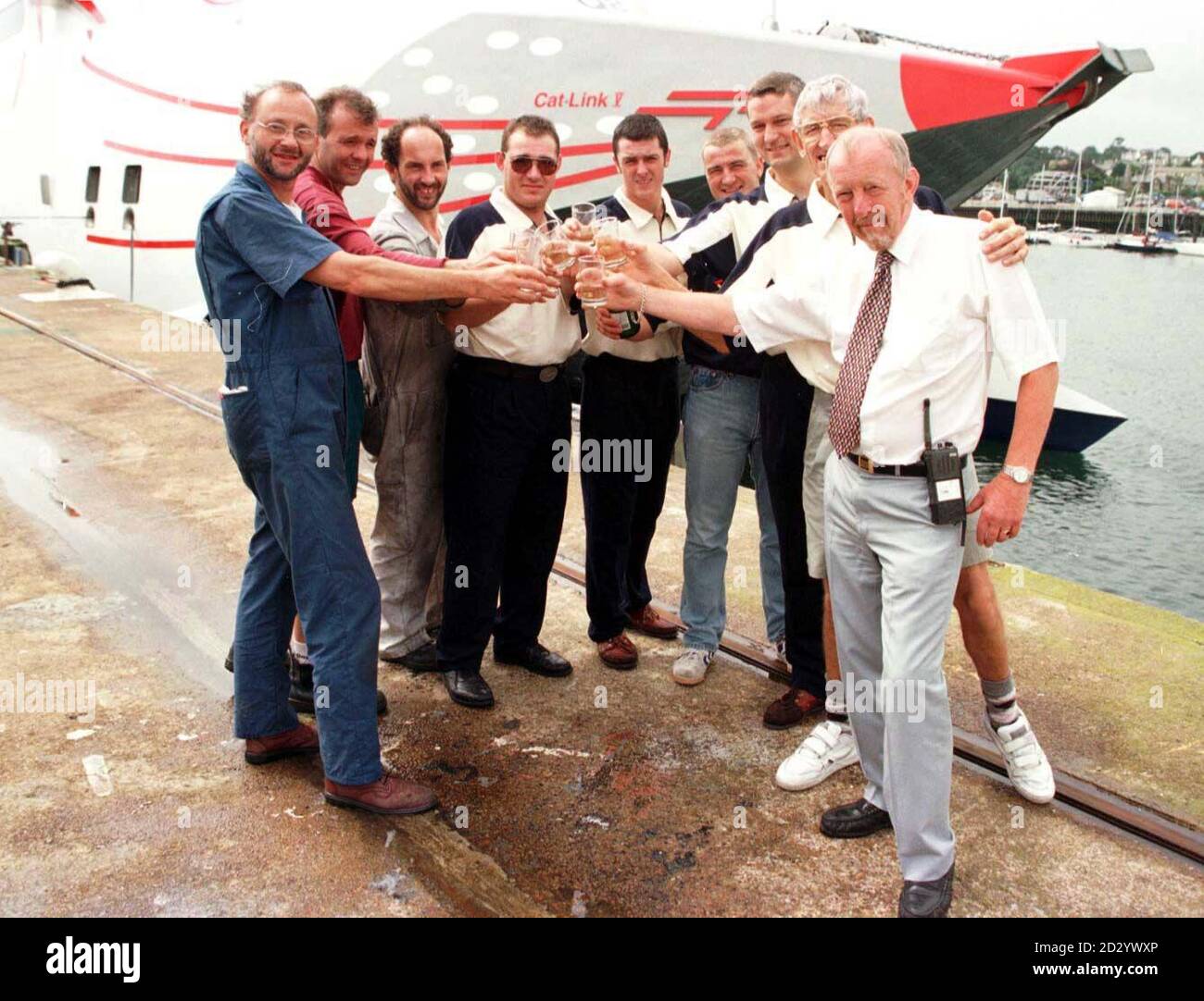 Officers and crew of the Cat Link V celebrate in Falmouth this morning ...