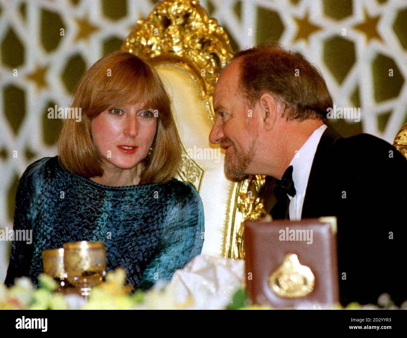 Foreign Secretary Robin Cook whispers to his wife Gaynor, during a ...