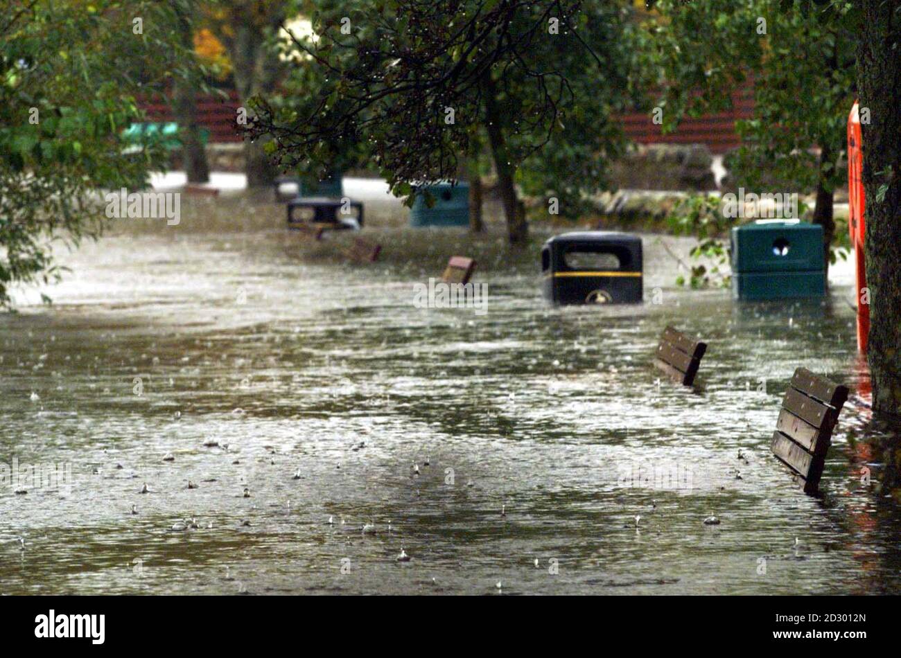 Park benches sit just above flood water hi-res stock photography and ...