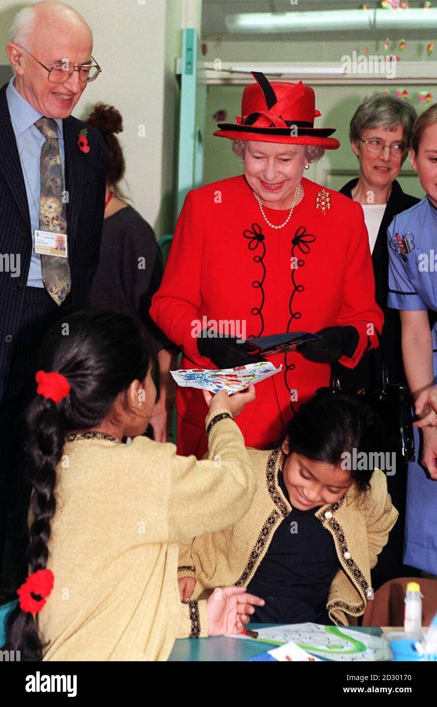 The Queen is offered a painting by a young patient, during her visit to ...