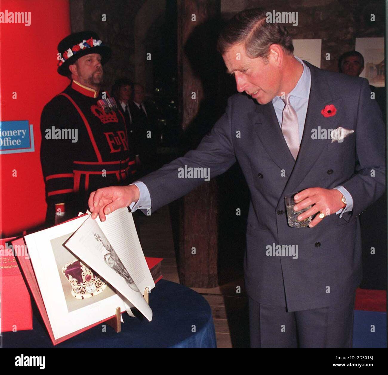 The Prince of Wales examines a copy of 'The Crown Jewels - The History ...