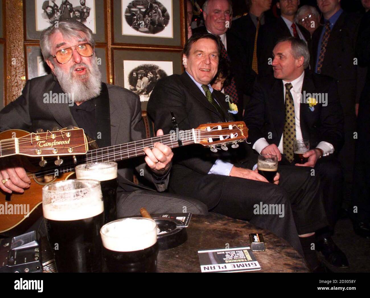 Irish Prime Minister Bertie Ahern (right) enjoys a pint with German ...