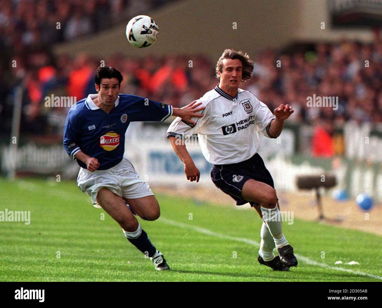 Leicester's Steve Guppy chases Tottenham's David Ginola during their ...