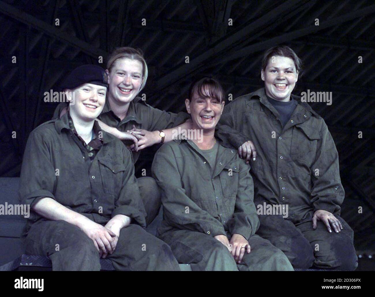 A team of British military truck drivers take a break from maintaining ...