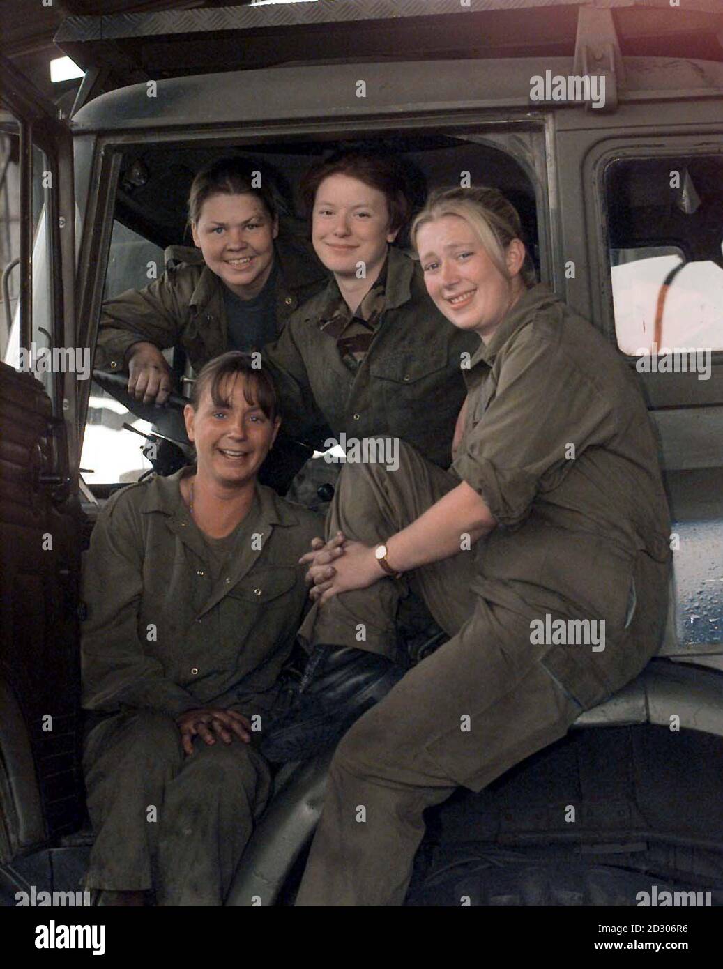 A team of British military truck drivers take a break from maintaining ...