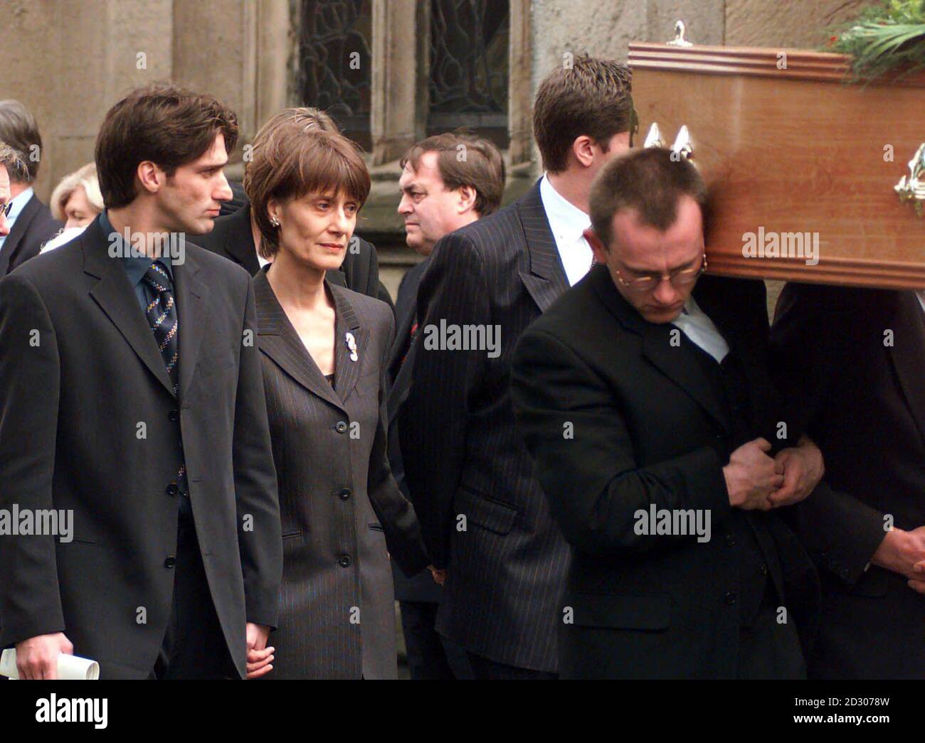 Derek Fatchett's wife and two sons (only one of them visible) follow ...