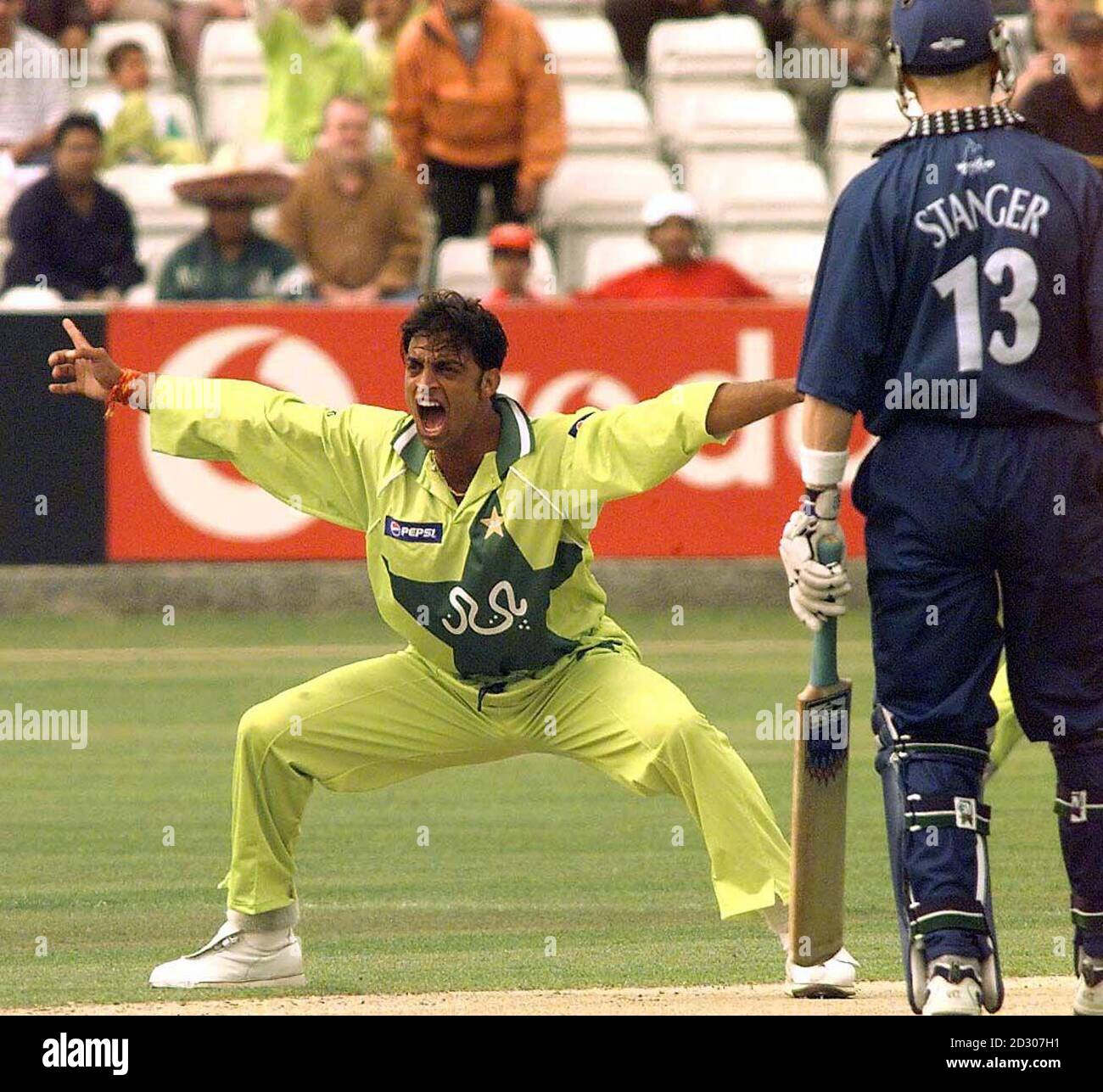 Shoaib Akhtar (L) celebrates taking the wicket of Scotland's George ...