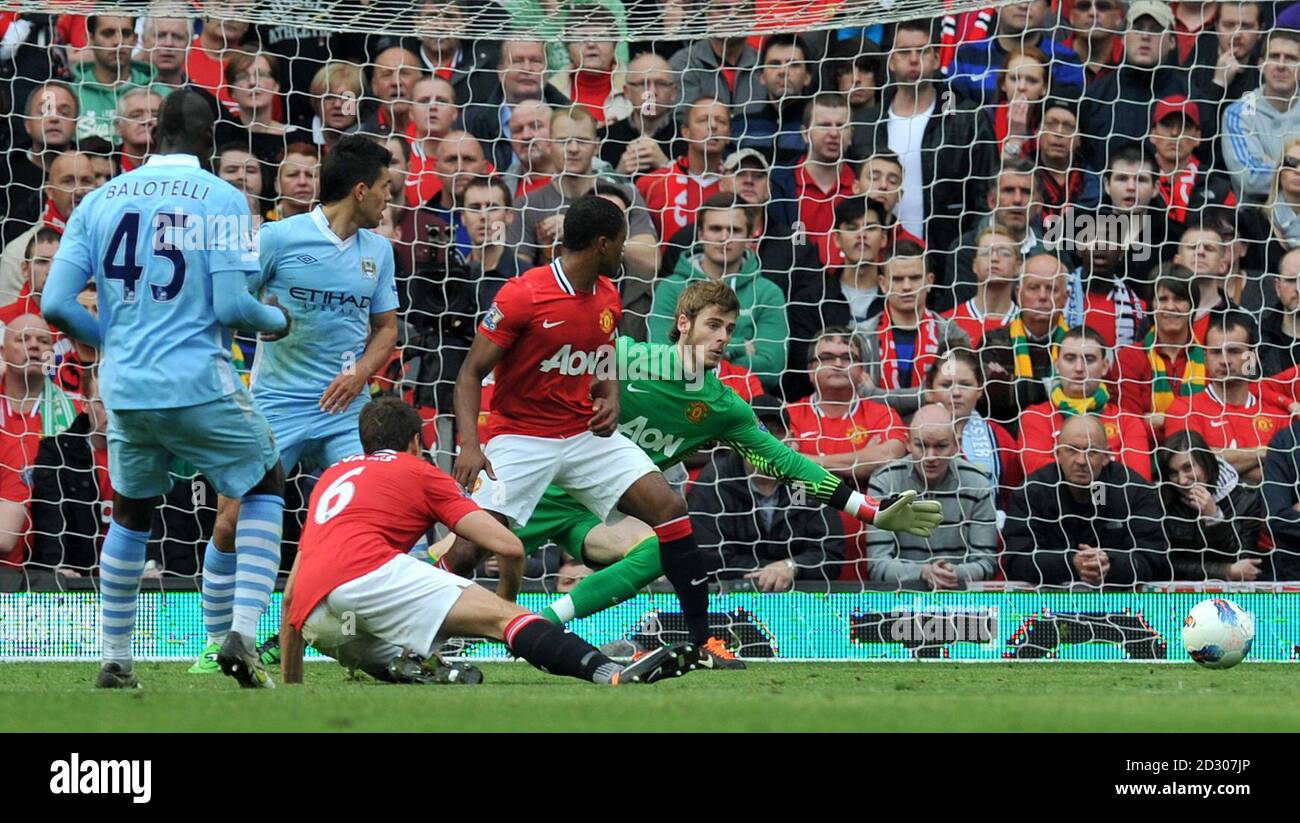 Manchester City's Mario Balotelli (left) scores during the Barclays ...