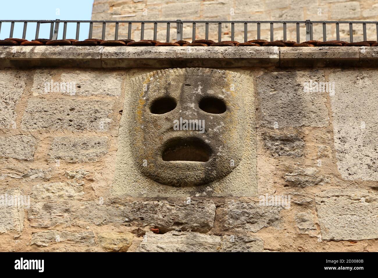 Low angle shot of a concrete face statue on the wall in Rothenburg ob ...