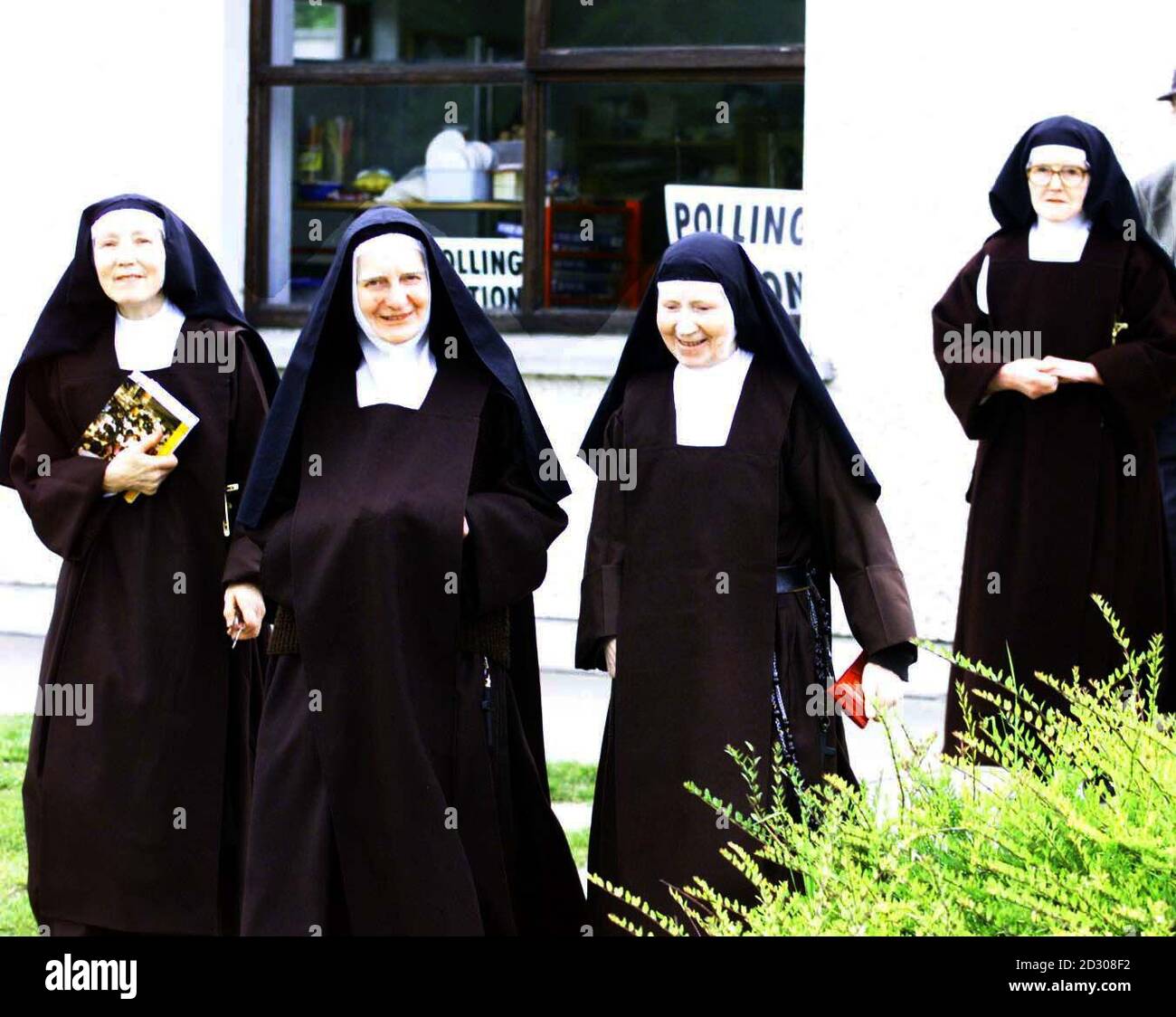 Nuns from the enclosed Order of the Carmelite Monastry, leaving a ...
