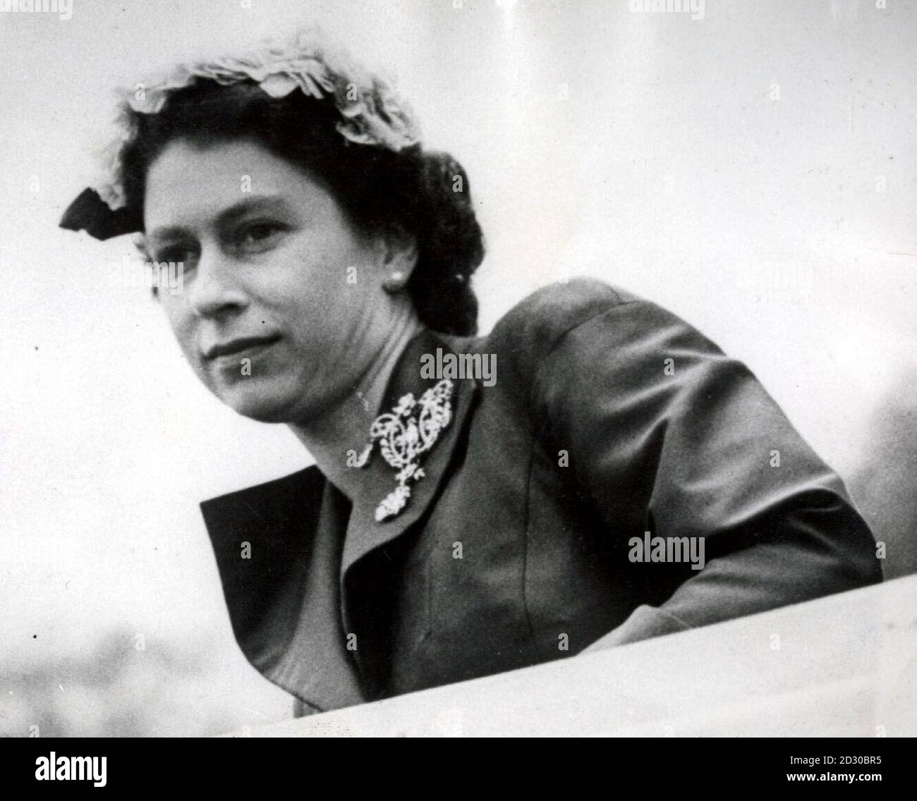 Queen Elizabeth II leans across the windshield of her Land rover when ...