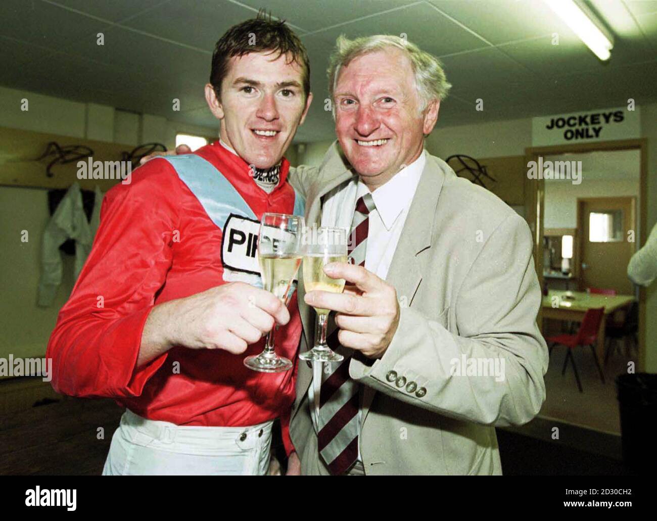 A moments time for celebration as trainer Martin Pipe (R) enjoys a ...