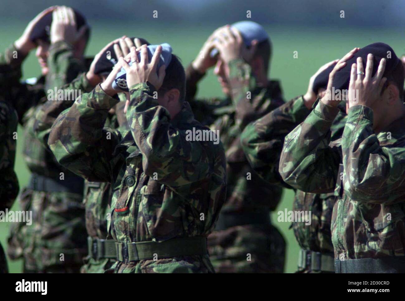Soldiers of the 16th Air Assault Brigade adjust their berets at a ...