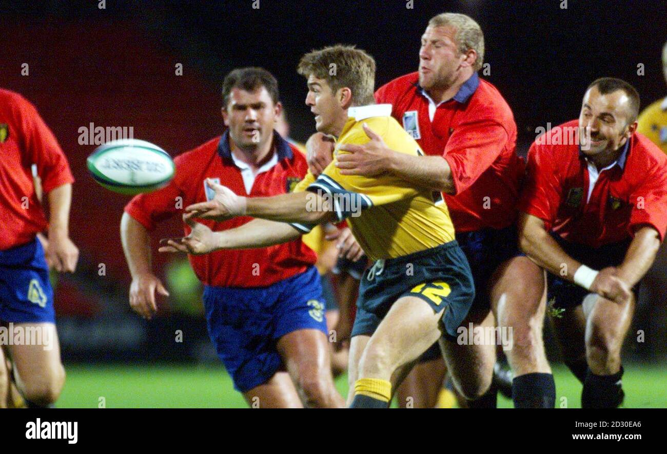 Australia's Tim Horan clears the ball before being brought down by ...