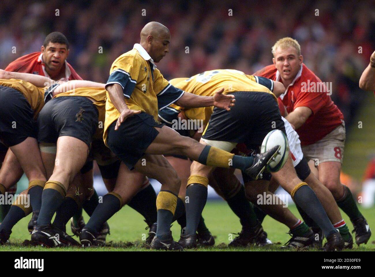 Austalian scrum half George Gregan gets the ball away as Wales's Colin ...