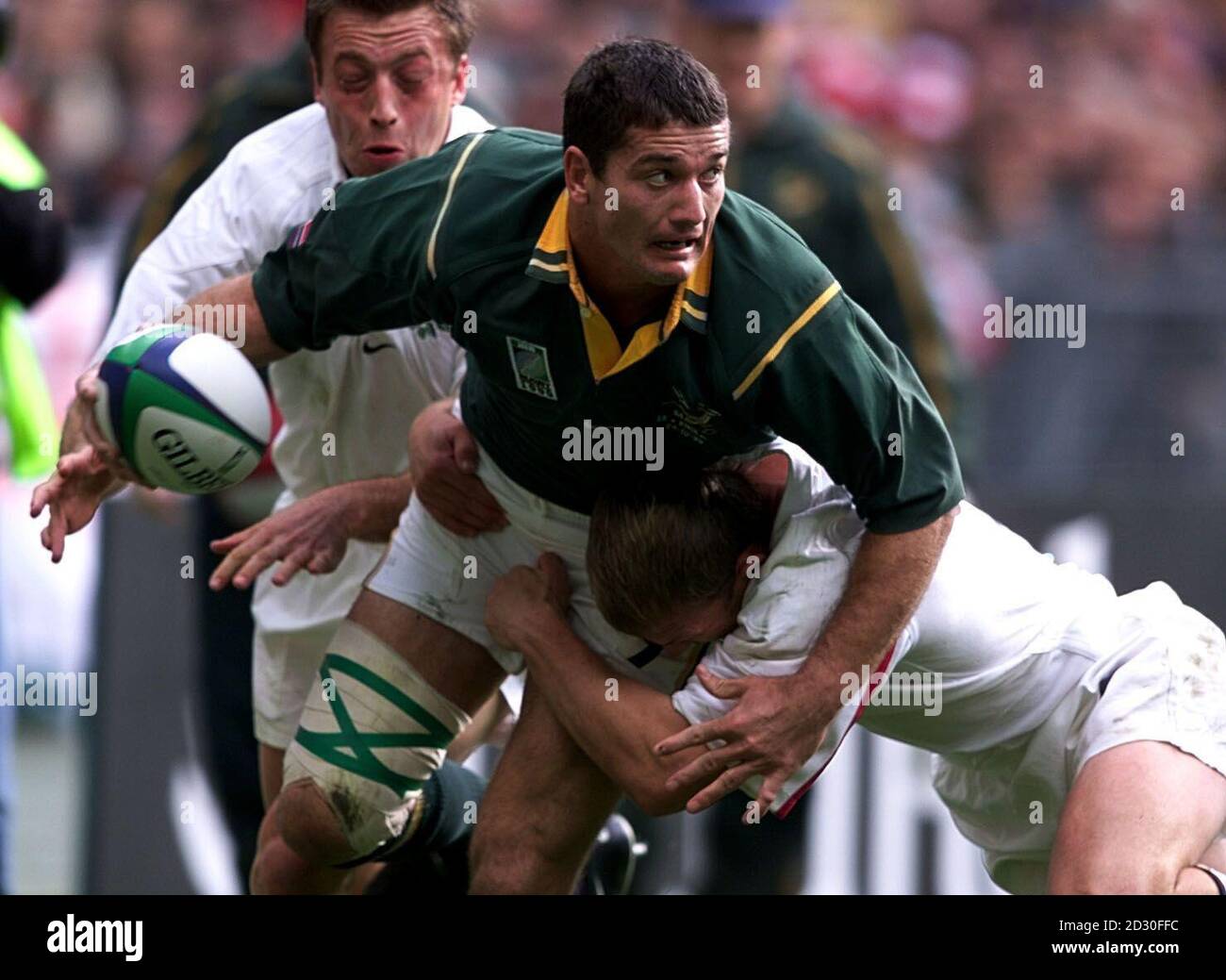 South African skipper Joost van der Westhuizen (centre) holds off ...