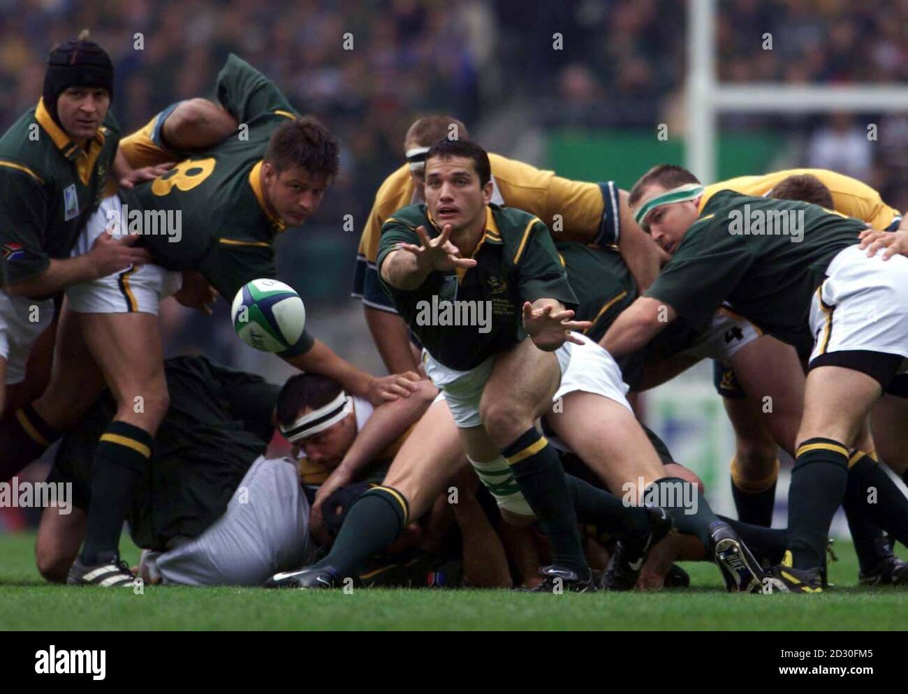 South African captain Joost van de Westhuizen (centre) clears the ball ...