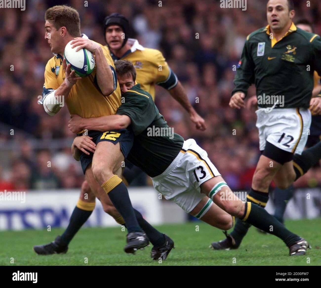 South Africa's Robbie Fleck (right) tackles Tim Horan of Australia ...